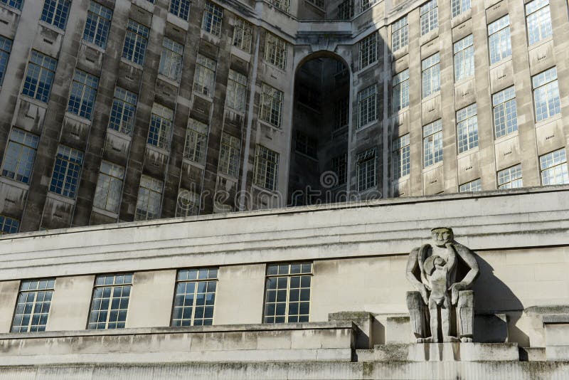 A Building Facade with a Sculpture of a Man and Child Stock Photo ...