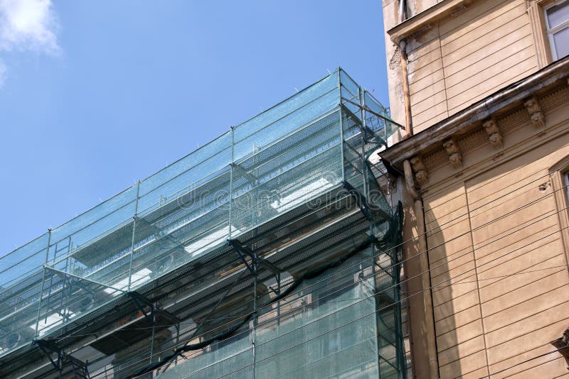 Building Facade Under Renovation Works with Construction Scaffolding ...
