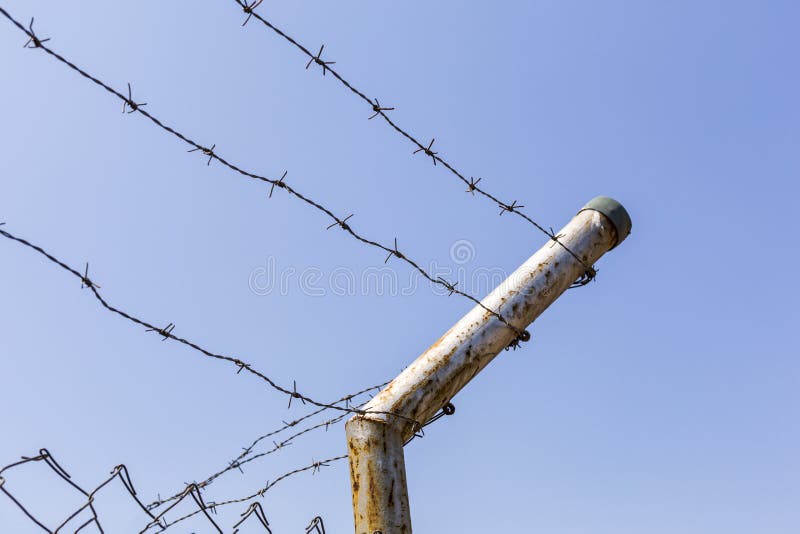 A Building Fence Surrounded by Barbed Wire Stock Image - Image of ...