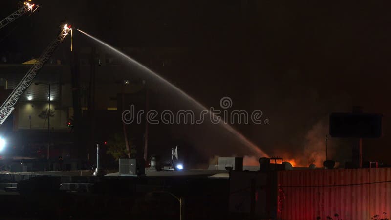 Firefighters in Elevated Platform Extinguish Burning House Using ...