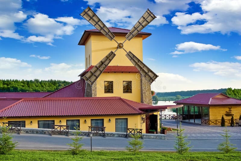 Building in the Form of Windmills on the Background of the Lake. Stock ...