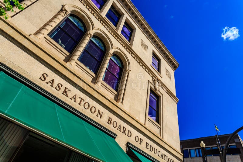 A Building with a Green Awning and the Words Saskatoon Board of ...