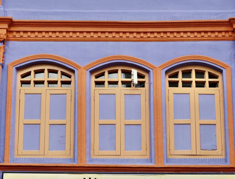 The Building Has Three Windows with a Brown Frame Stock Photo - Image ...