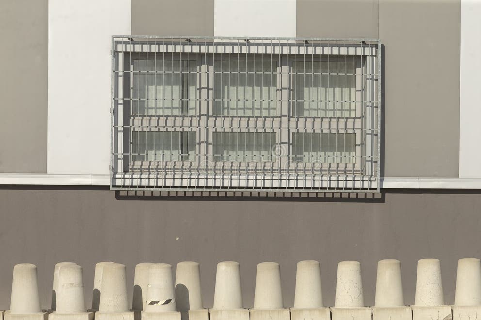 A Building Has a Window with a Fence in Front of it Stock Photo - Image ...