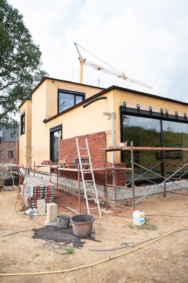 Building a House Supporting Structure for Laying Bricks Around a Wooden ...