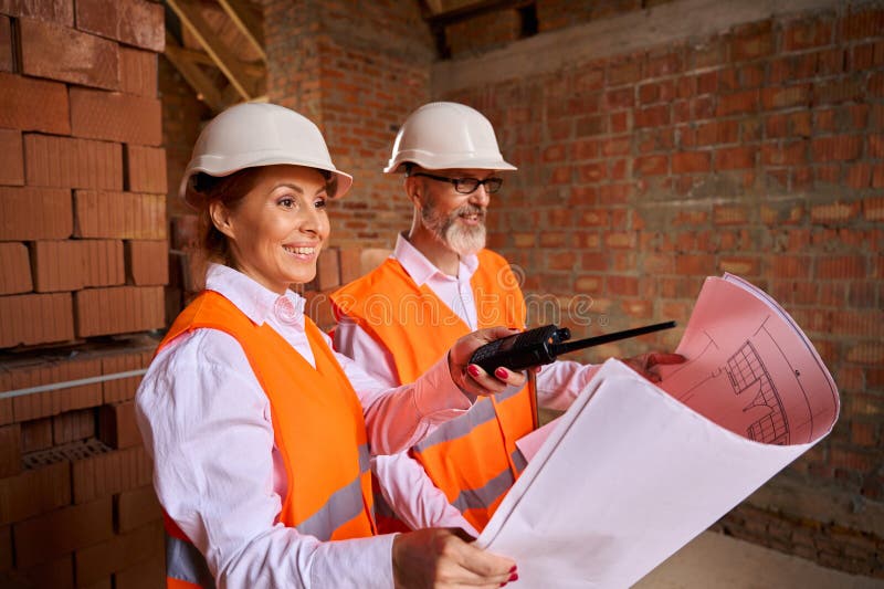 Building Inspector and Contractor are Using Blueprints during Site ...