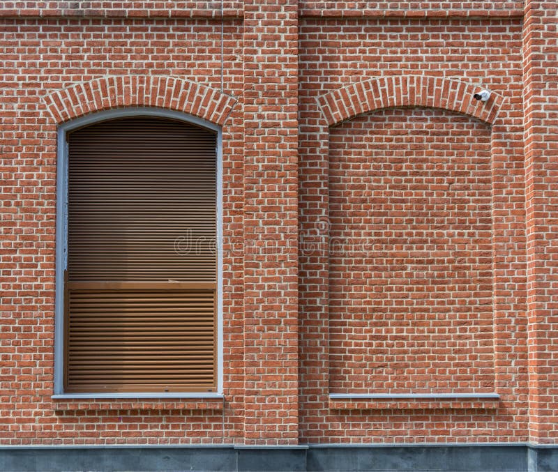 The Building is Made of Brick in Loft Style. Window with Blinds and a ...