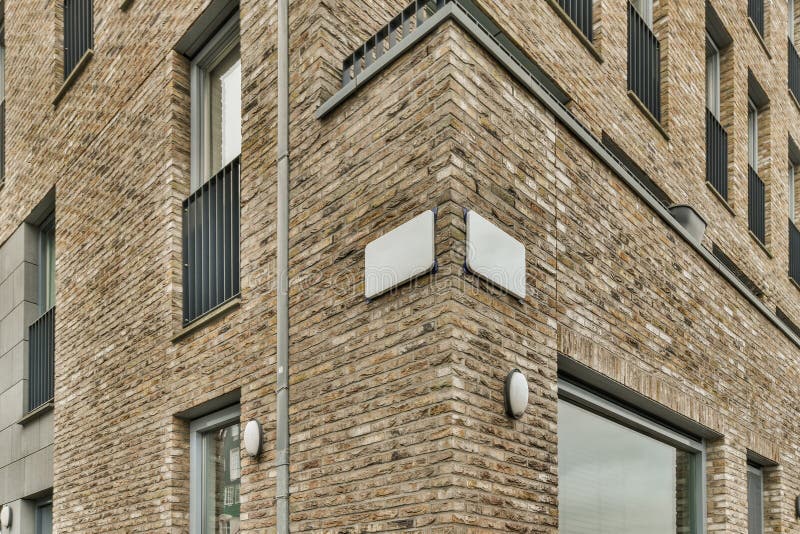 The Corner of a Brick Building with Two Windows Stock Photo - Image of ...