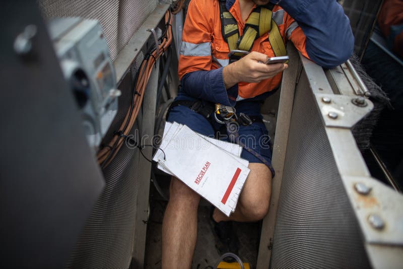 Building Maintenance Worker is Using Cellphone Calling Site Emergency ...