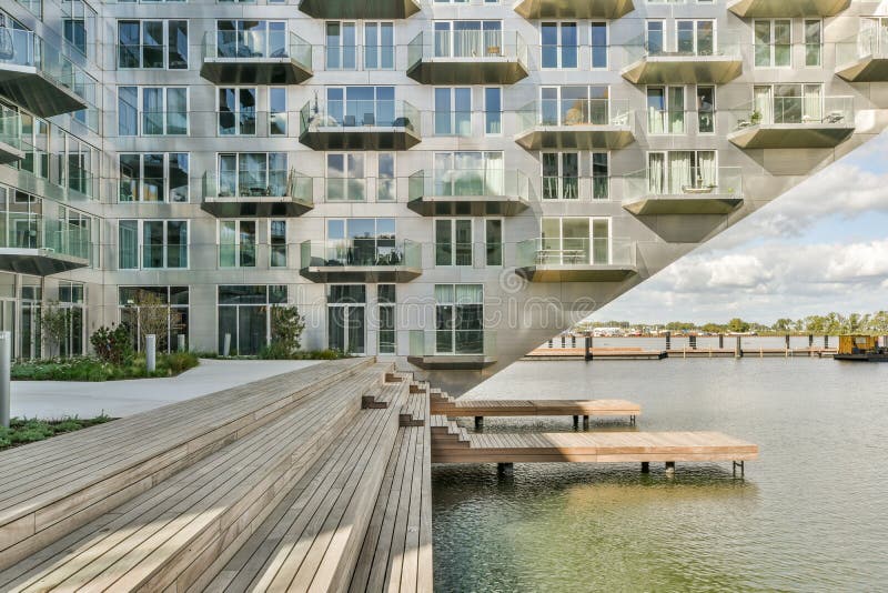 A Pier in Front of a Building with a Lake Stock Photo - Image of ...