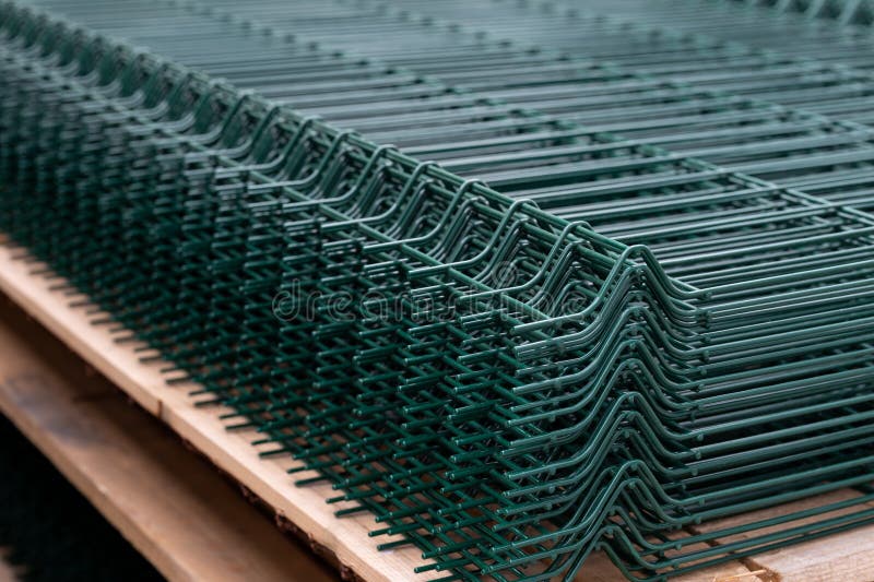 Building Materials. Green Sections of Wire Mesh for Fencing on Racks in ...