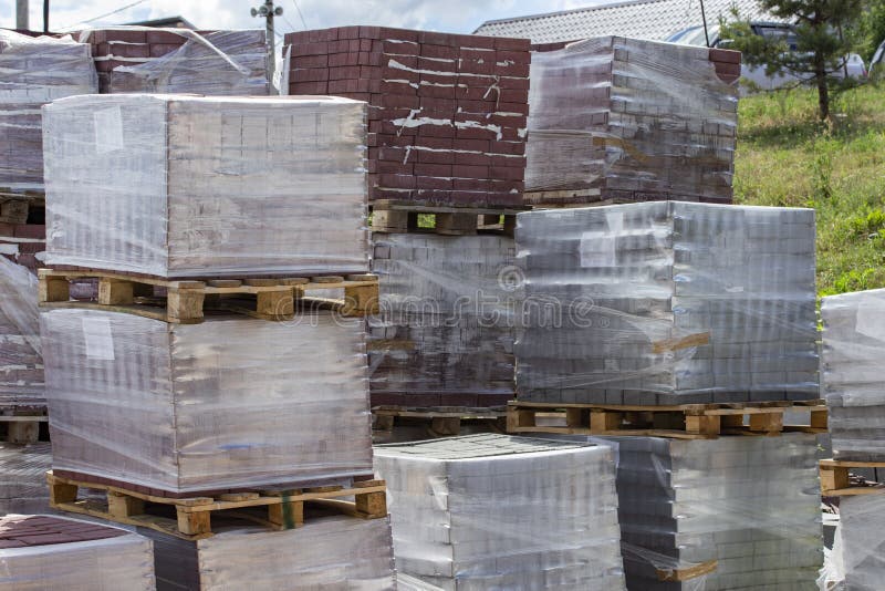Building Materials on Pallets, Red Bricks Paving Stone. Warehouse ...
