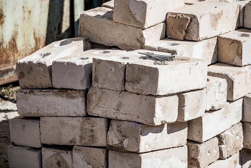 Building Materials on Site. Construction Nails on Stack of White Bricks ...