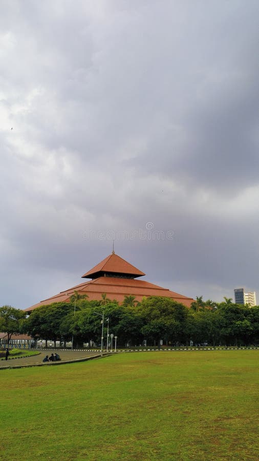 A Building in the Middle of a Green Field with a Clear Blue Sky Stock ...