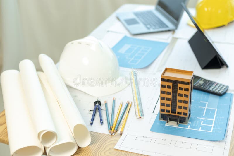 Building Models and Blueprints are Placed on Work Desks in the ...