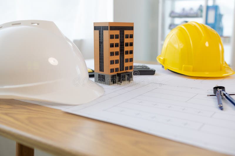 Building Models and Blueprints are Placed on Work Desks in the ...