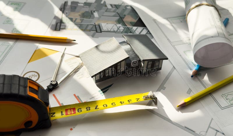 Building Models and Blueprints are Placed on Work Desks in the ...