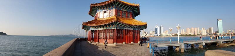 A Building that is Near the Water by Itself and Has a Clock on it ...