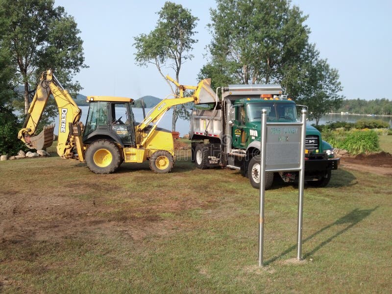 Backhoe Loader and Dump Truck Editorial Photo - Image of working, lake ...