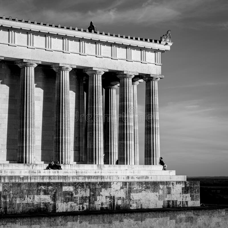 A Building with Pillars and Windows is Shown Against the Sky Stock ...