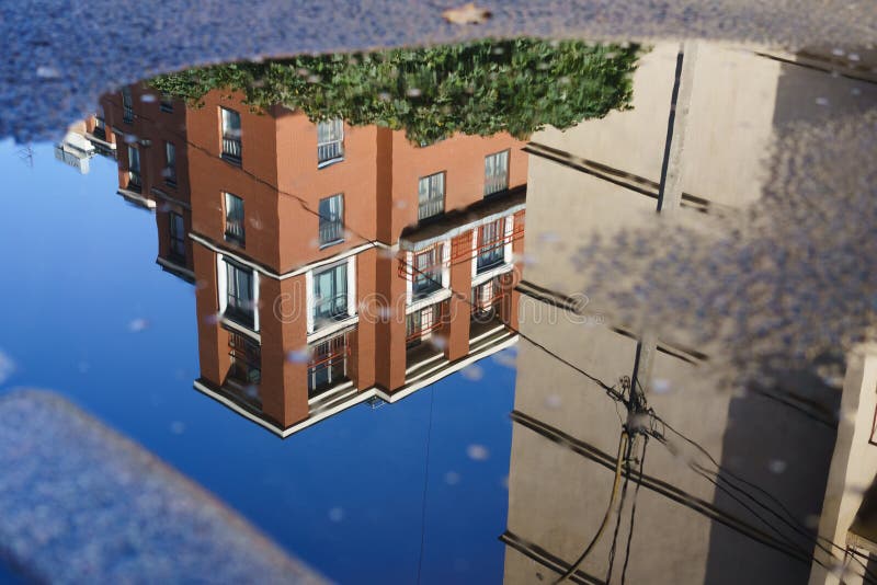 Building is Reflected in a Puddle of Water Stock Photo - Image of glass ...