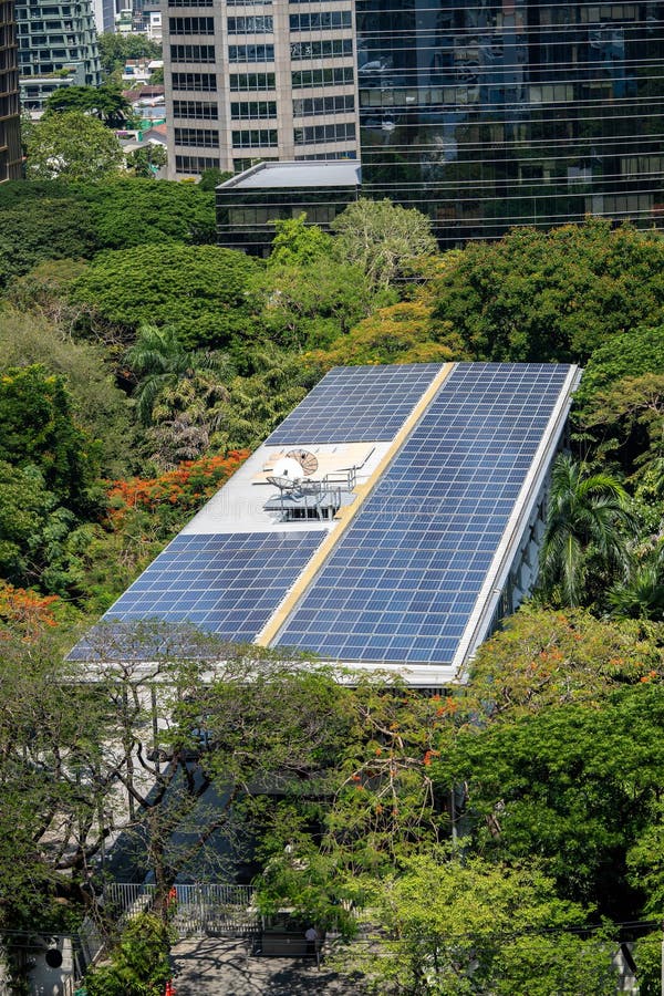 Building Rooftop with Solar Panels Energy Efficiency Surrounded by Trees. Ecological ...