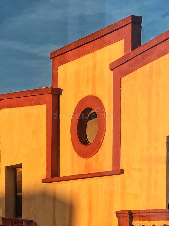 Building with Round Window with Orange Facade and Sunset Light. Stock ...