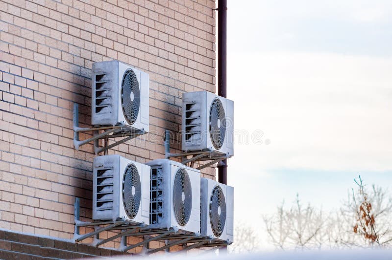 A Building S Exterior Showcases Several Air Conditioning Units Covered ...