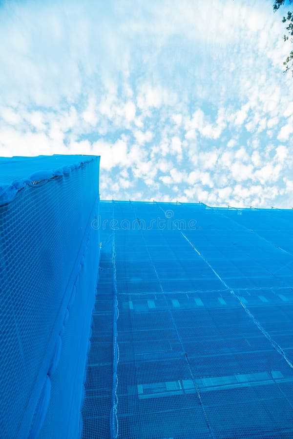 Building Scaffolding Construction Frame with Blue Safety Net Stock ...