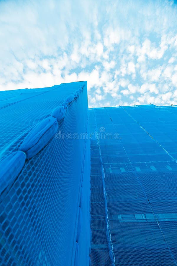 Building Scaffolding Frame with Blue Safety Net Stock Photo - Image of ...