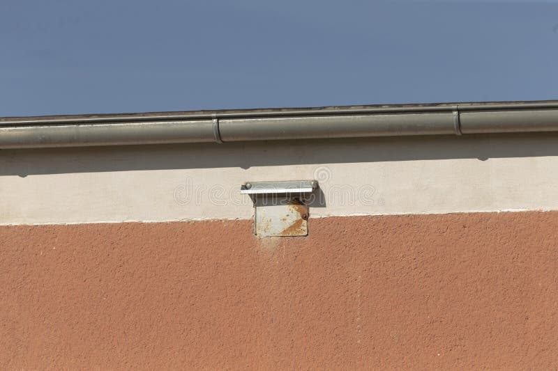 A Building with a Side Gutter and a Blue Sky Behind it Stock Photo ...