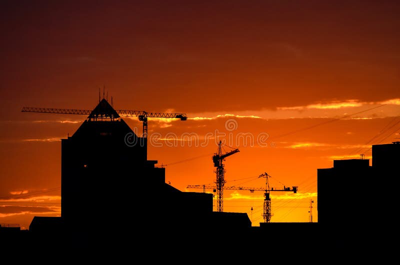 Building Silhouettes and Cranes at Sunset Stock Image - Image of ...