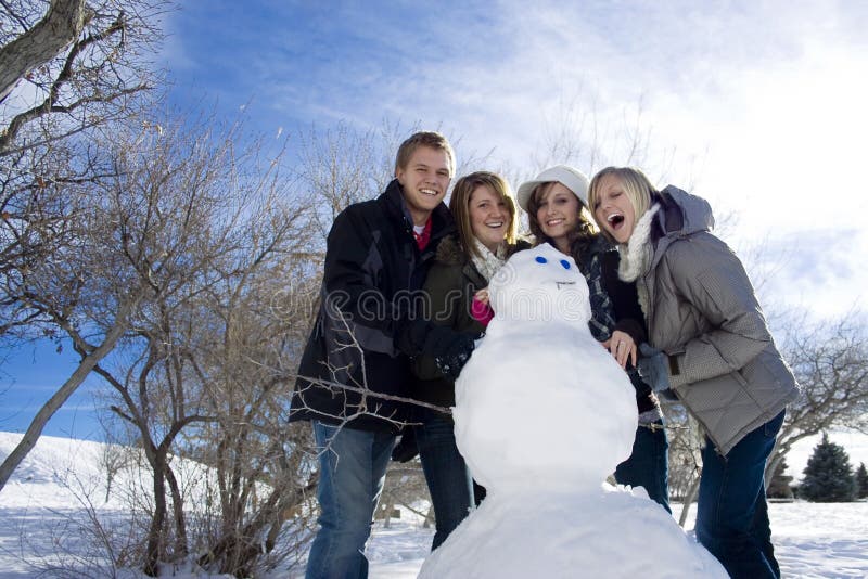 Building a Snowman with Friends Stock Photo - Image of gloves, building ...