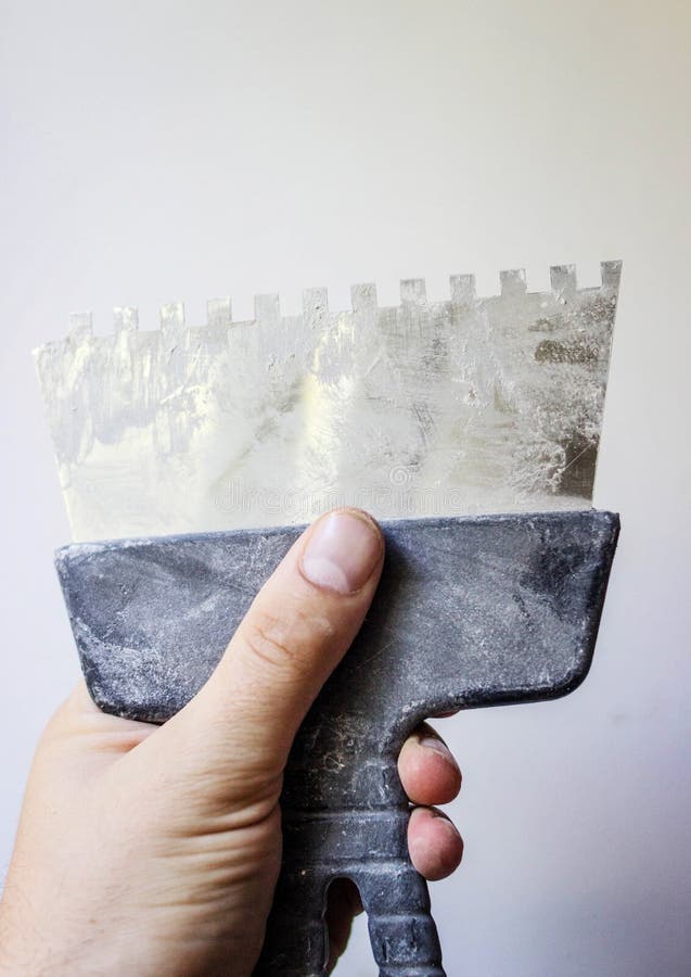 Building spatula in hand stock image. Image of renovation - 96209205