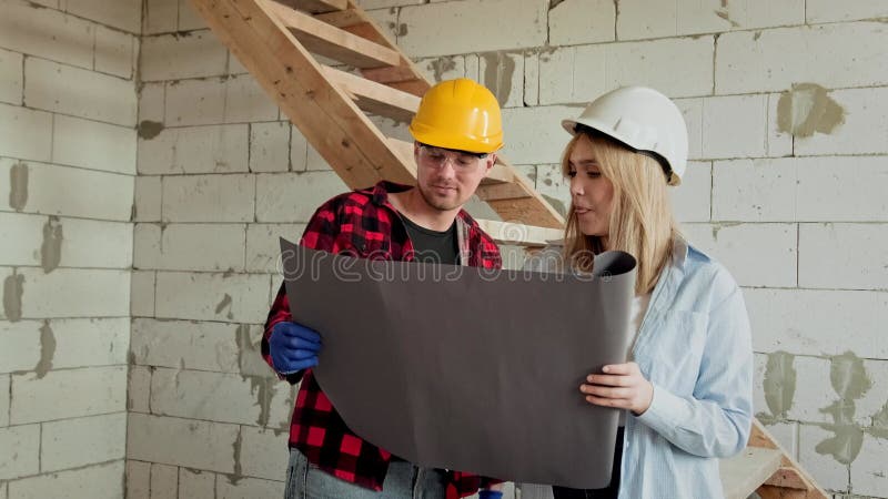 Building Specialists with Blueprints Inspecting Dwellings Under ...