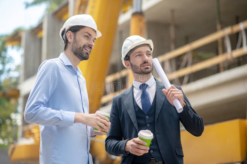 Building Supervisor and Foreman Drinking Coffee, Discussing Something ...