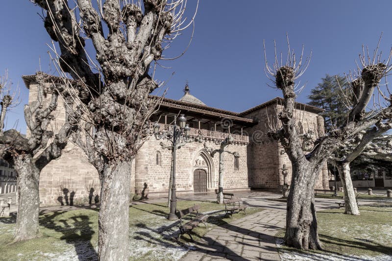 A Building with Two Trees in Front of it. the Trees are Bare and the ...