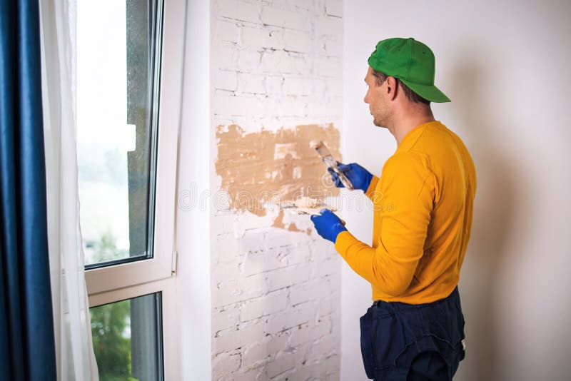 Building Under Construction with Bricklayer Plastering Concrete To ...