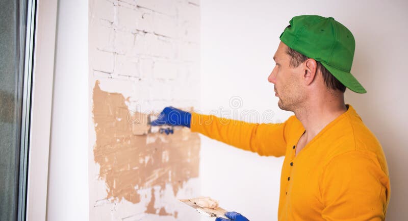 Building Under Construction with Bricklayer Plastering Concrete To ...