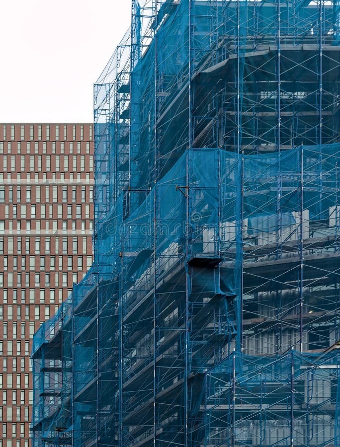 Building Under Construction Covered in Blue Mesh Tarp Protective Wrap ...