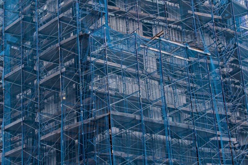 Building Under Construction Covered in Blue Mesh Tarp Protective Wrap ...