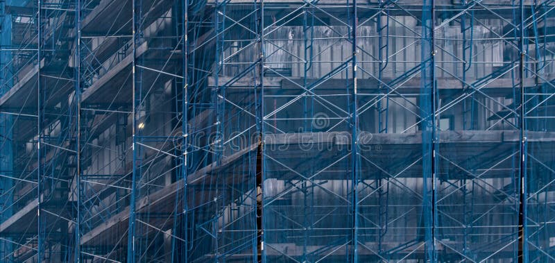 Building Under Construction Covered in Blue Mesh Tarp Protective Wrap ...