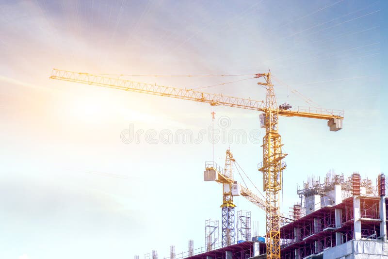 Building Under Construction with Hoisting Cranes Working To Move ...