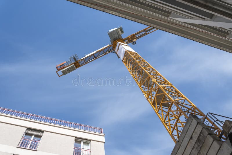 Building Under Construction and Orange Crane among City Walls Stock ...