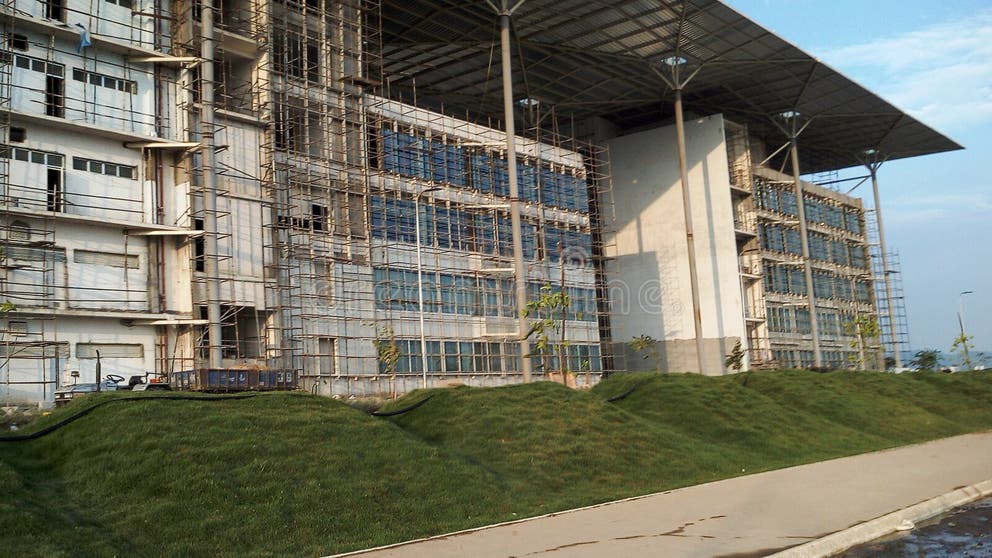 A Building Under Construction and a Greenery Made for Decoration in ...