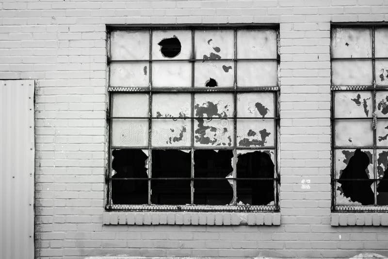 Building Wall with Broken Windows in the City with Shuttered Doors ...