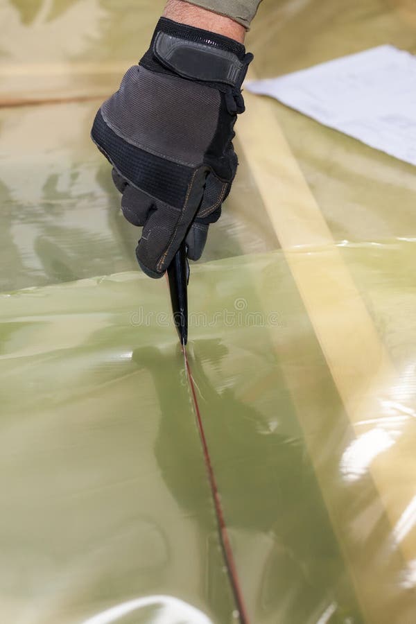 Building a Wall for Frame House. Worker Cutting a Protective Film ...