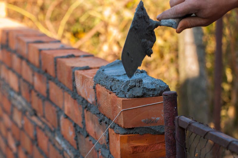 Building a Wall with Red Brick. Working with Bricks for Building a Wall ...