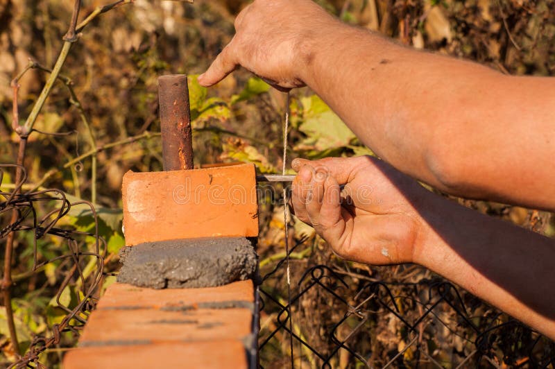 Building a Wall with Red Brick. Working with Bricks for Building a Wall ...