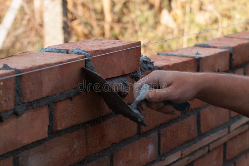 Building a Wall with Red Brick. Working with Bricks for Building a Wall ...